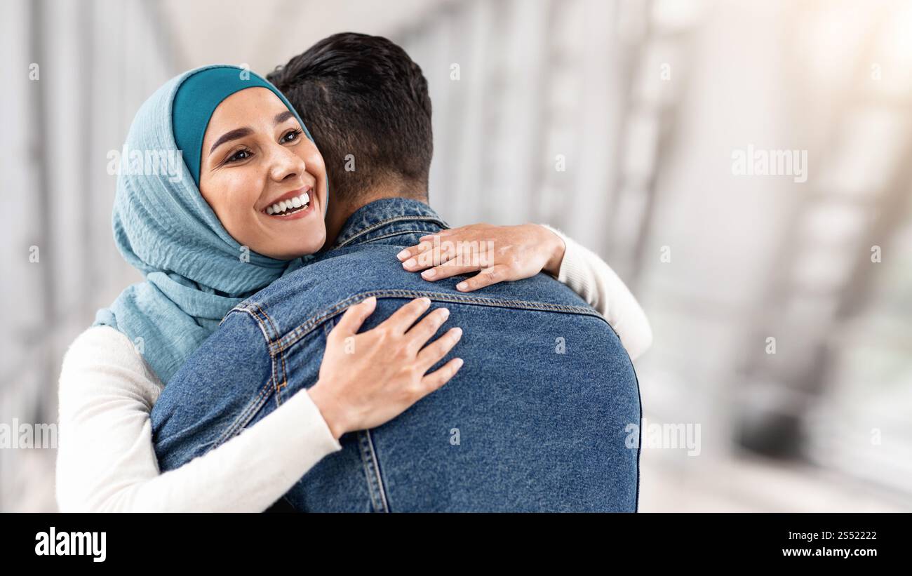 Happy Reunion. Joyful Muslim Woman In Hijab Hugging Her Husband At ...