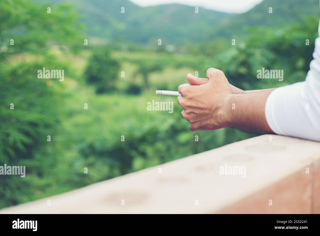 Young hipster man taking rest, smoking cigarette with nature and. Young ...