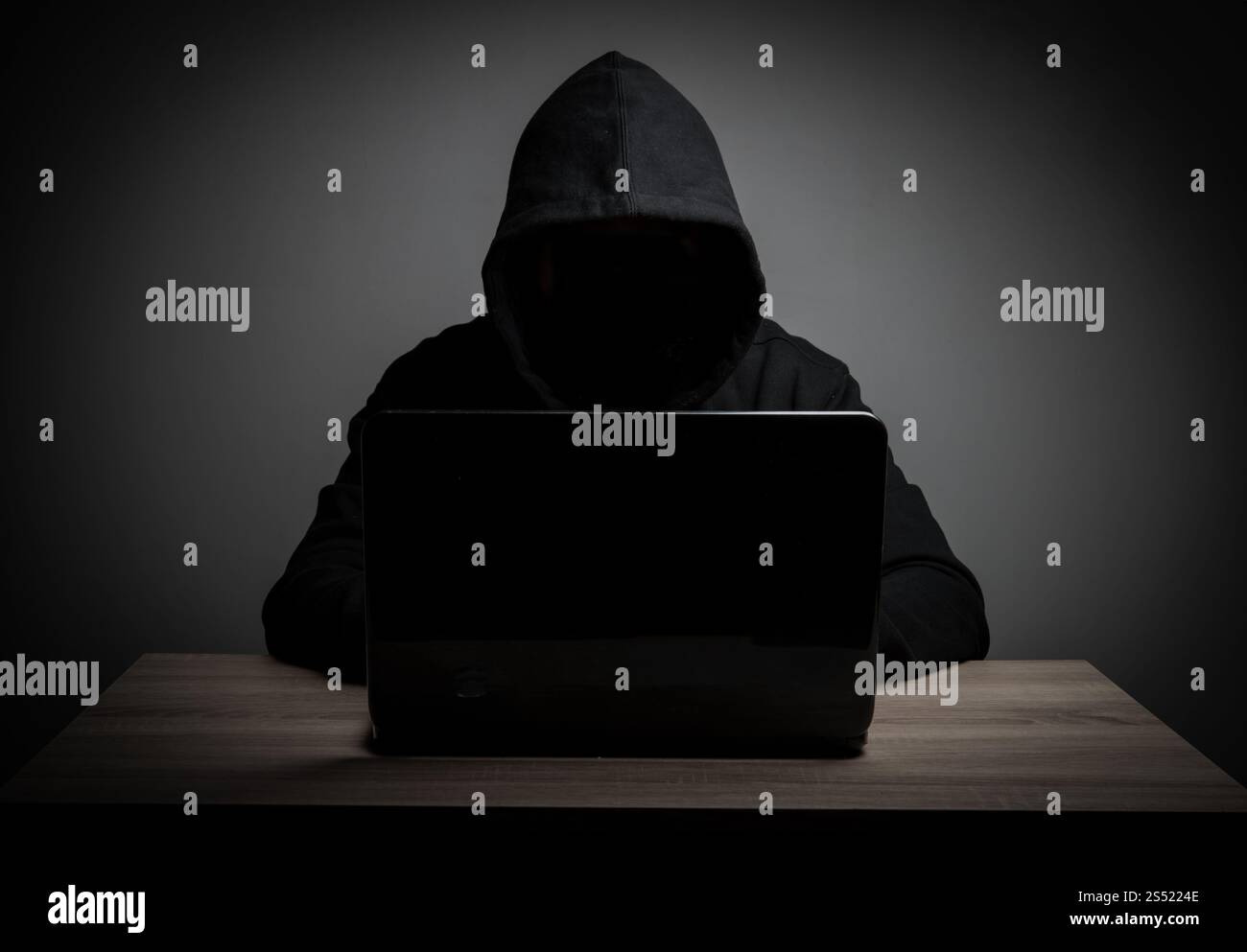 Hacker work front of his laptop computer with dark face Stock Photo - Alamy