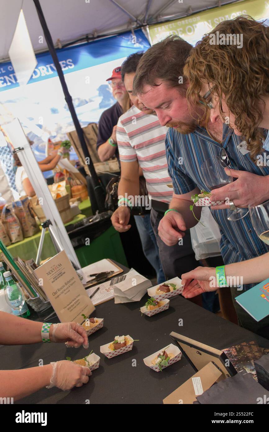 People Sampling Food at an Outdoor Culinary Event Stock Photo - Alamy