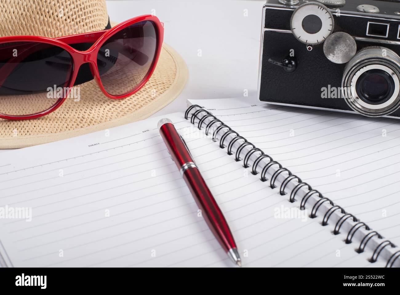 Hat, sunglasses and vintage camera with notepad isolated on a wh. Hat ...