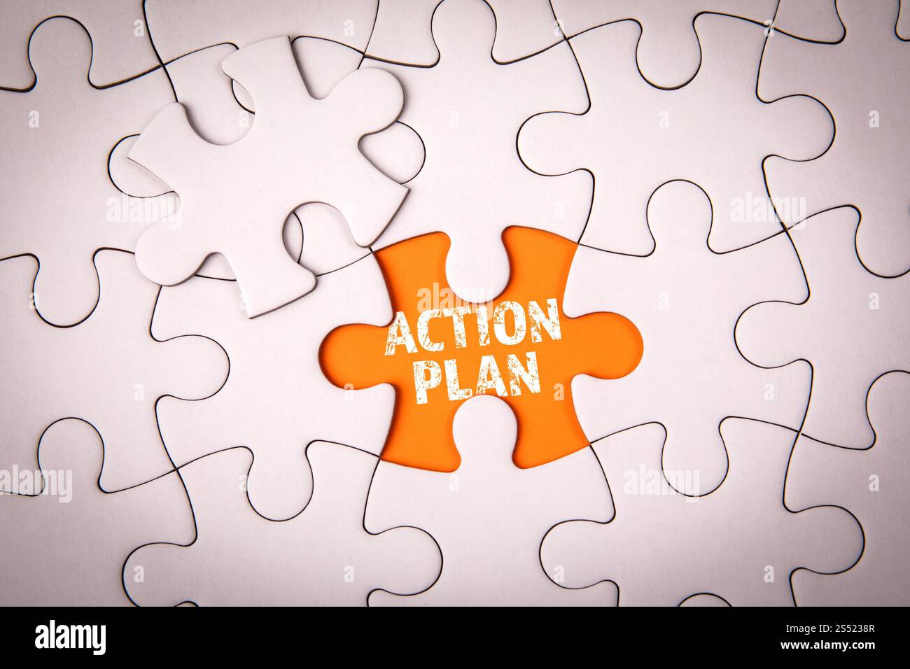 Action Plan. White puzzle pieces and text on an orange background Stock ...