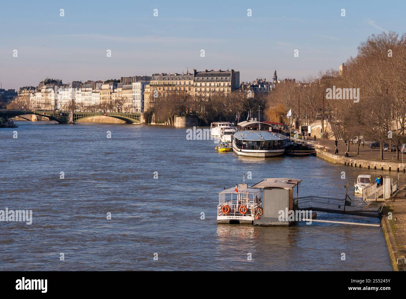 Beautiful riverside view in Paris with boats and historic buildings ...
