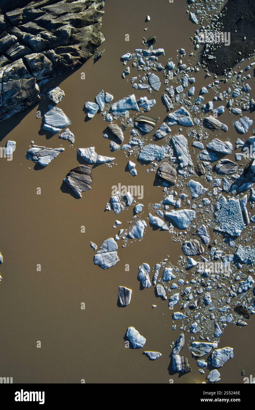 Aerial view of floating ice chunks in a glacial lagoon, surrounded by ...