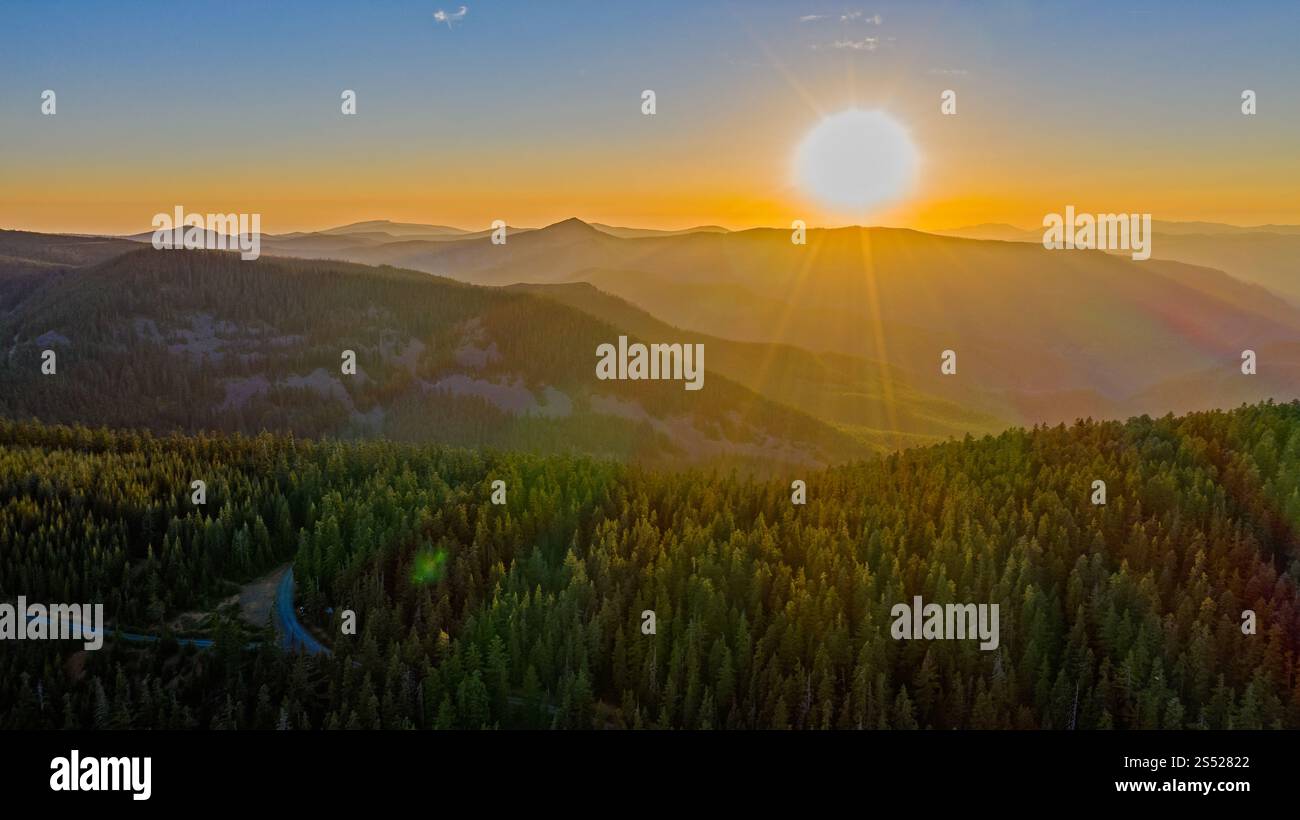 Scenic Mountain Sunset Above a Dense Forest Landscape Stock Photo - Alamy