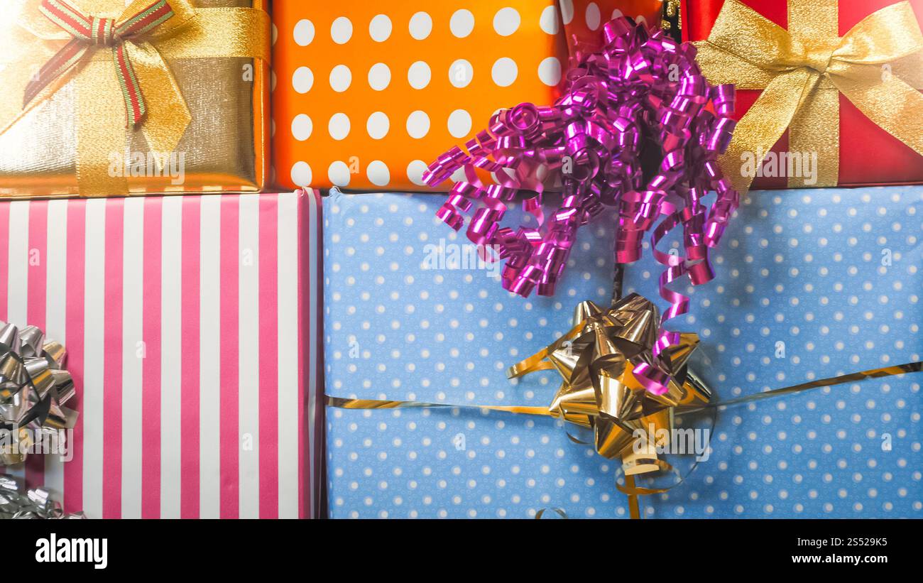 Closeup photo of lots of gift boxes decorated with ribbons and bows ...