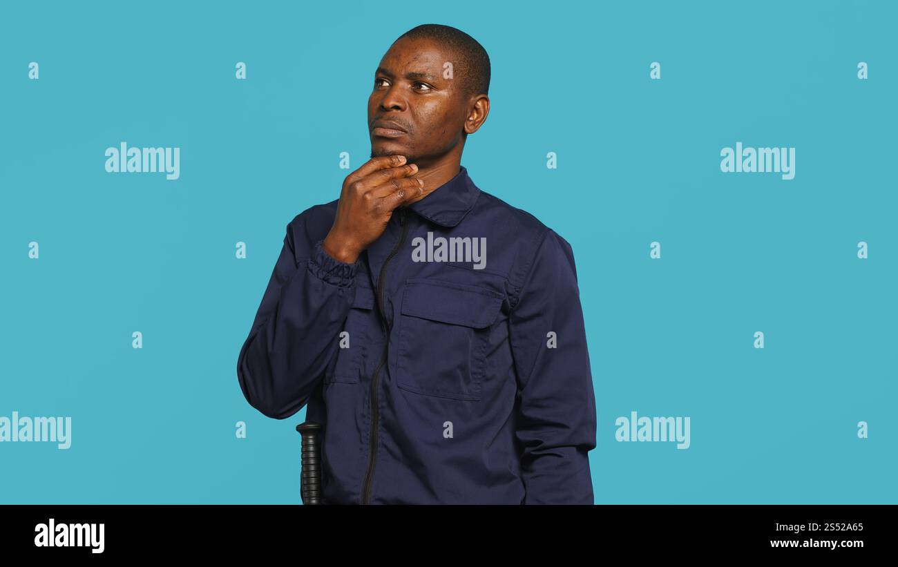 Security guard doing thinking hand gesture during surveillance shift ...