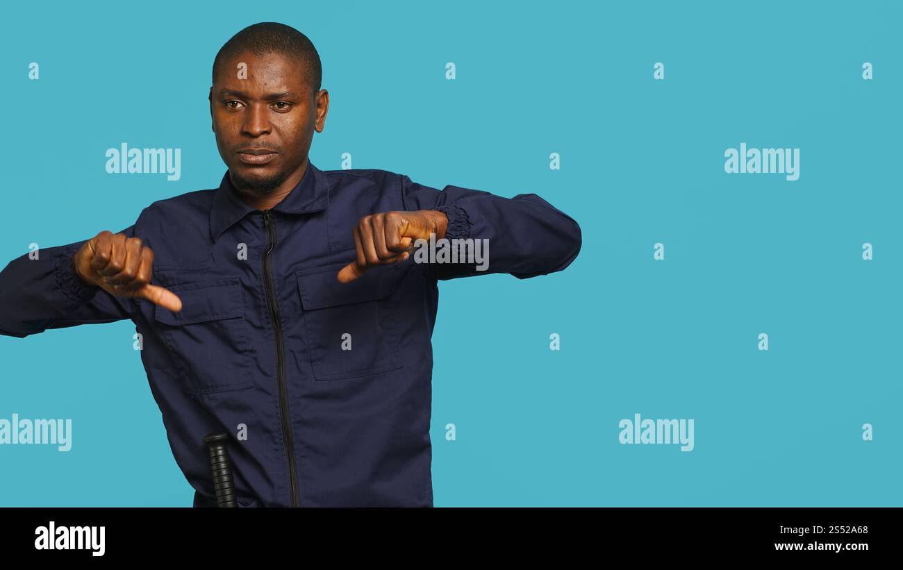 Security guard doing thumbs down sign gesturing, denying public access ...