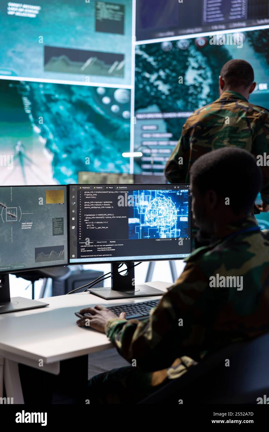 Military experts in a mission control center use modern technology on ...
