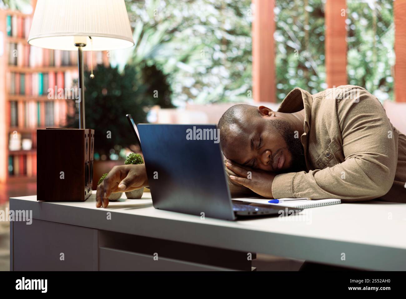 Small business owner feels tired and takes a nap while doing remote ...