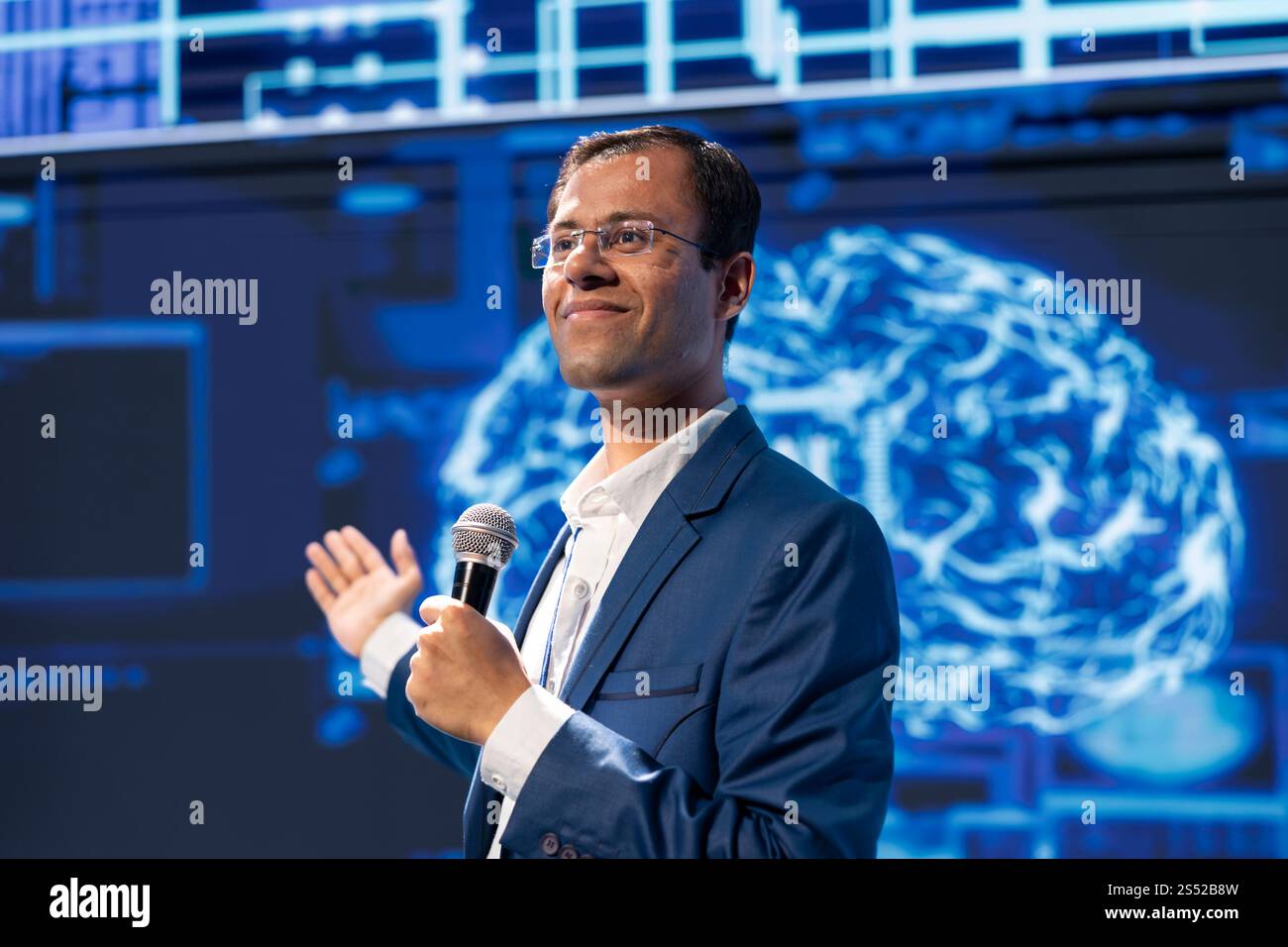 Smiling speaker speaking at tech conference, exploring latest AI ...