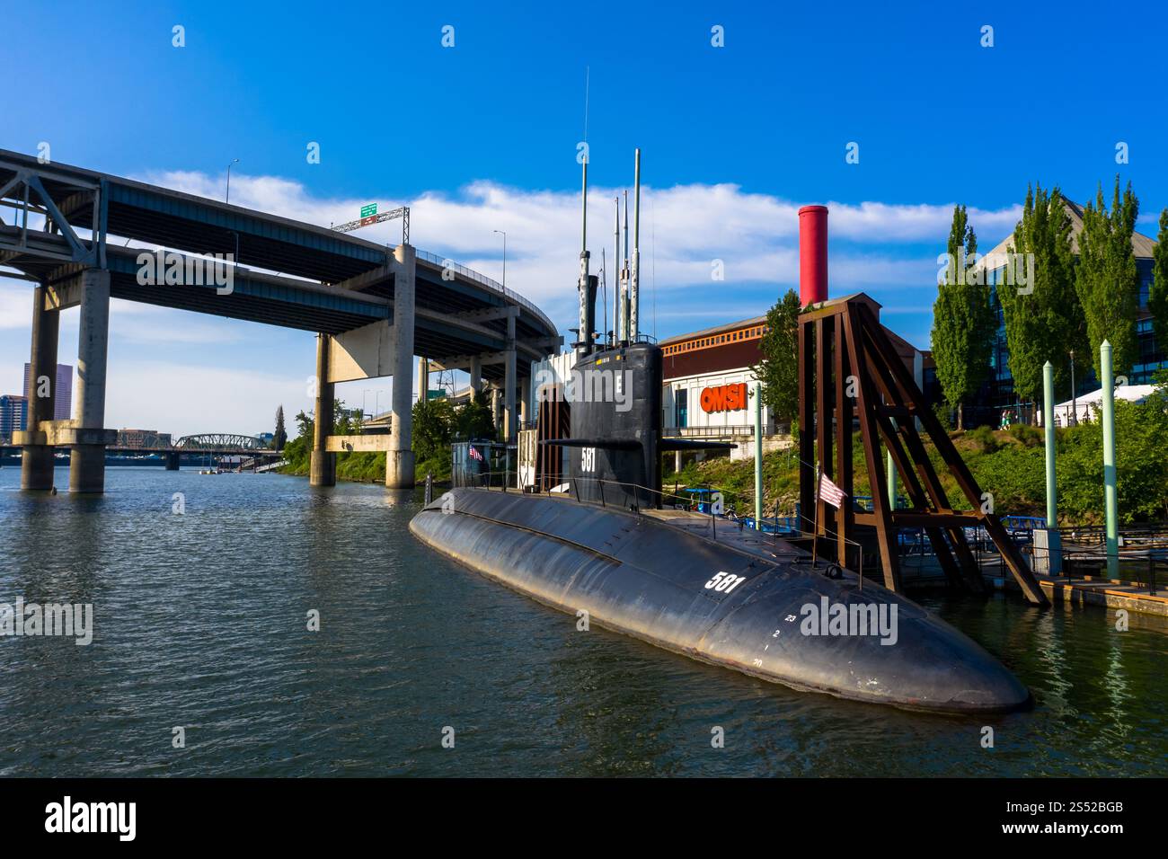 Submarine Docked by Waterfront Under a Clear Blue Sky and Modern Bridge ...
