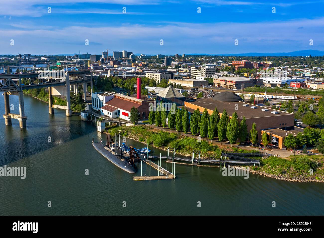 Submarine Docked by Waterfront Under a Clear Blue Sky and Modern Bridge ...