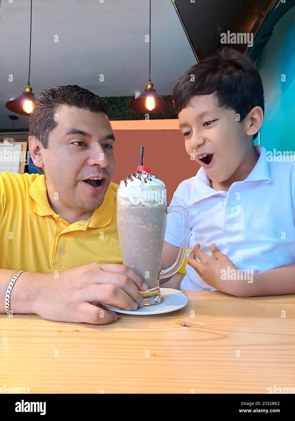 Divorced single dad with his 9 year old son have a milkshake in a ...