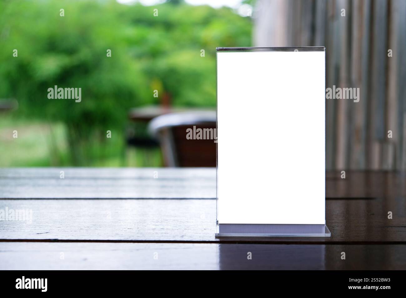 Menu frame standing on wood table in Bar restaurant cafe. space for ...