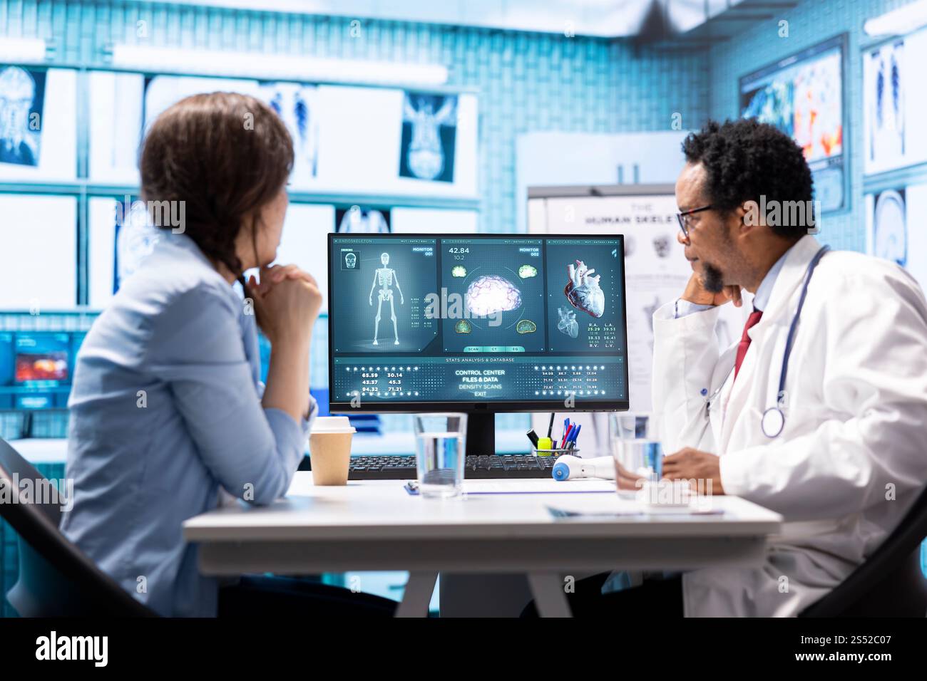 Physician reviewing MRI scan and x ray test results with a patient in ...