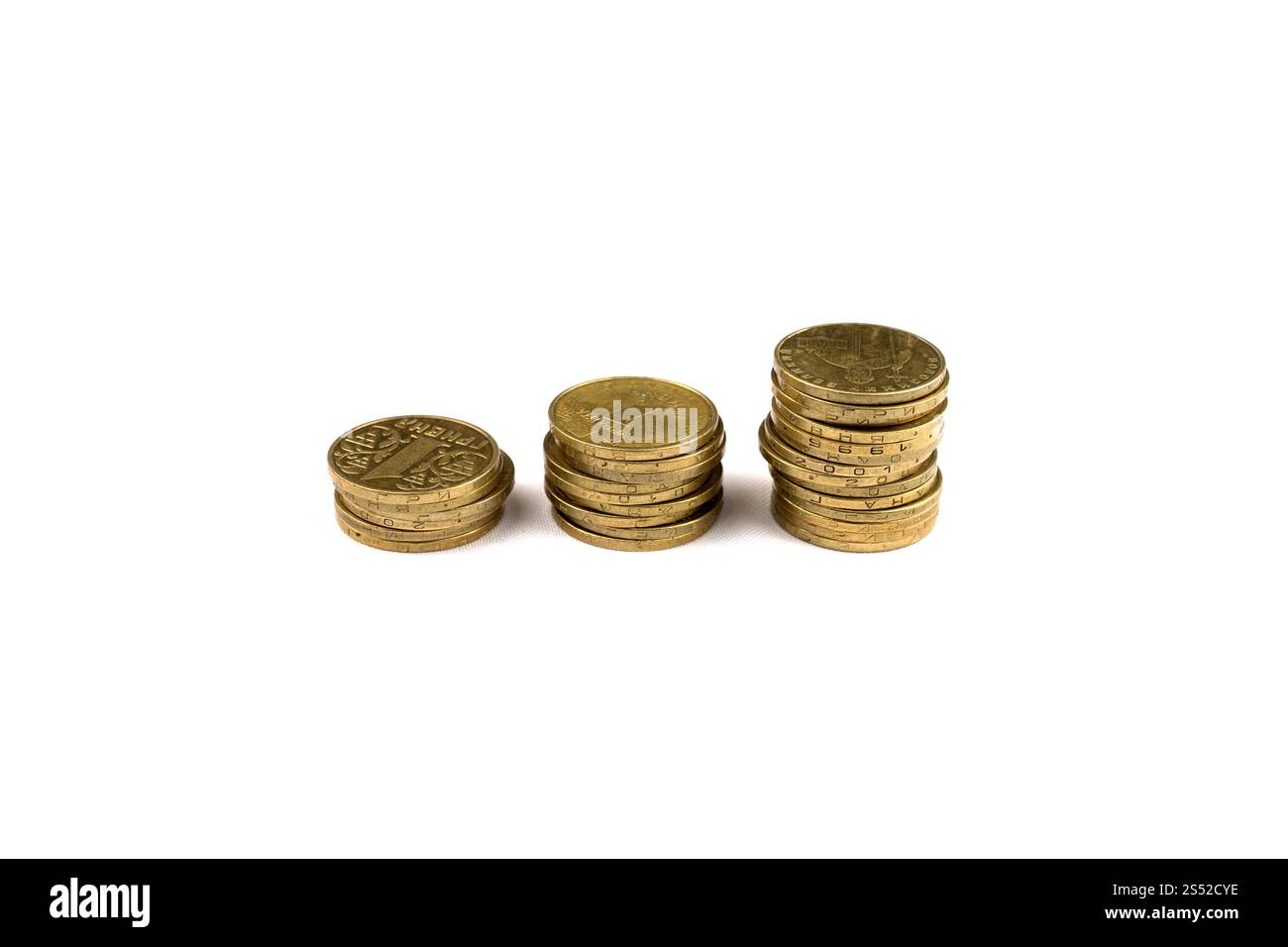 Stacked coins of various sizes and values on a simple background Stock ...