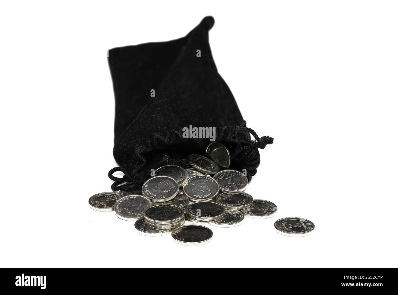 Collection of coins spilling from a black pouch on a white background ...