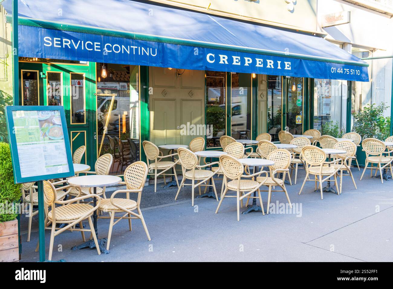 Cozy outdoor seating at a creperie in a lively neighborhood Stock Photo ...