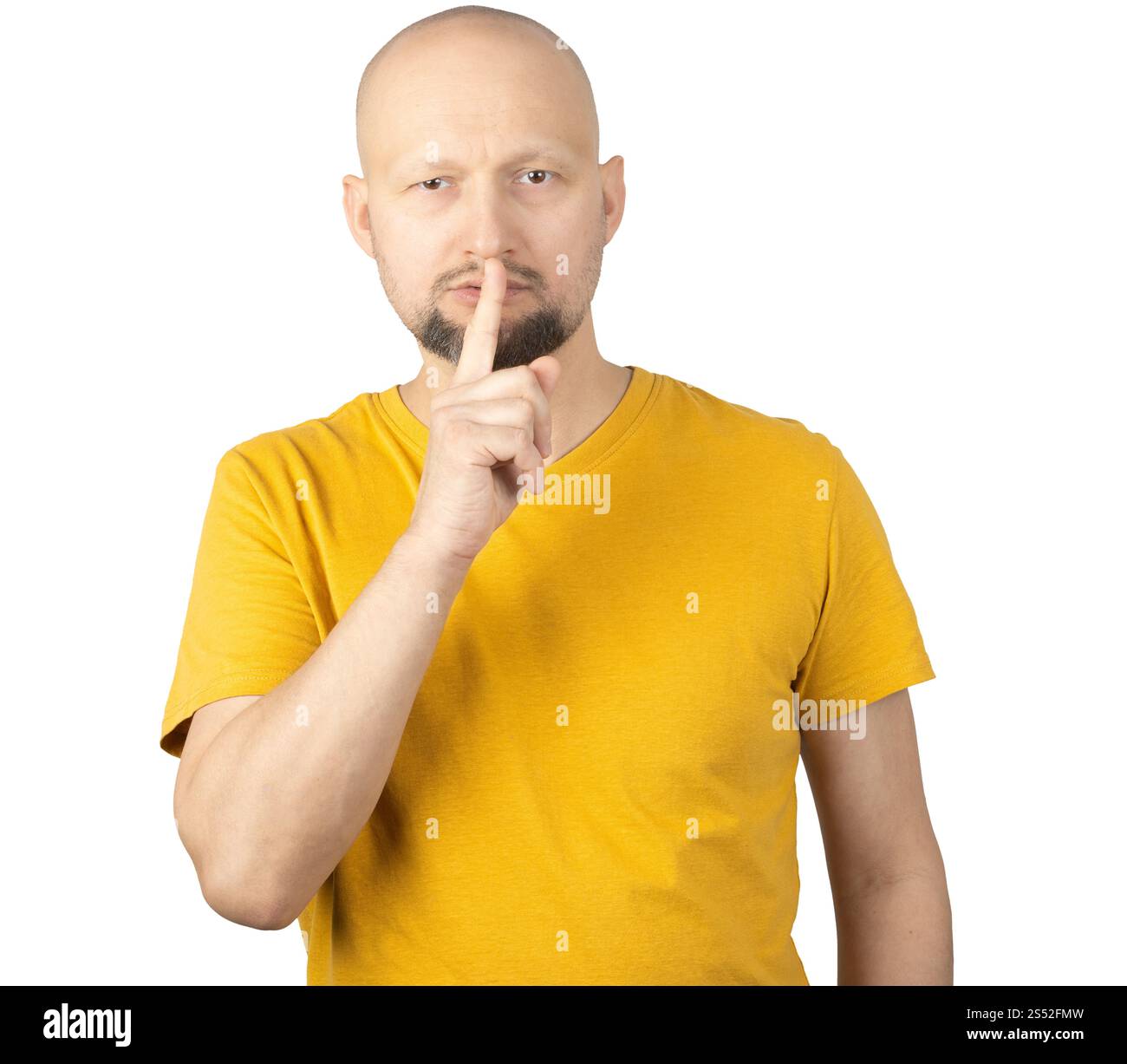 A bald man with a short beard wearing a yellow t-shirt poses against a ...