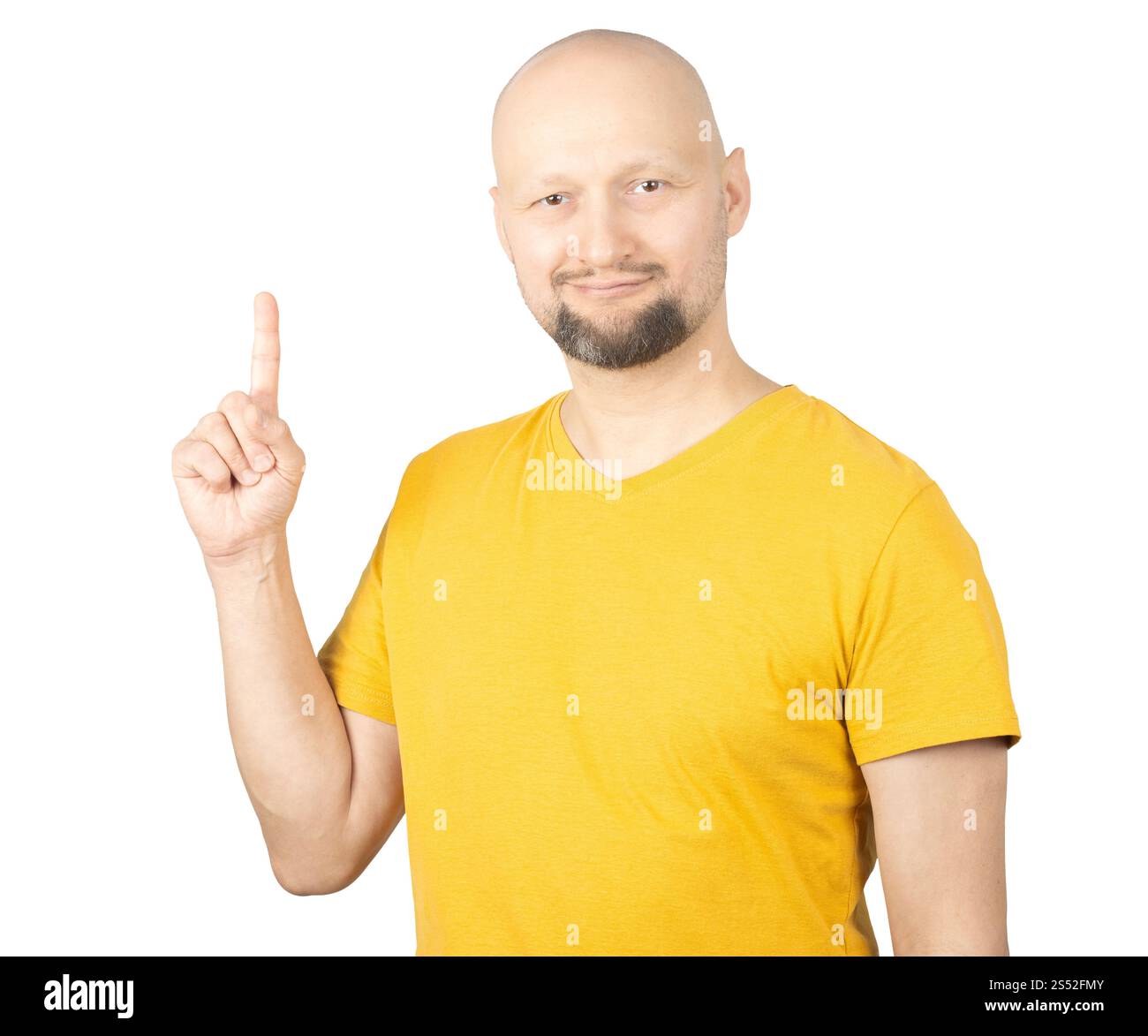 A bald man with a short beard wearing a yellow t-shirt poses against a ...
