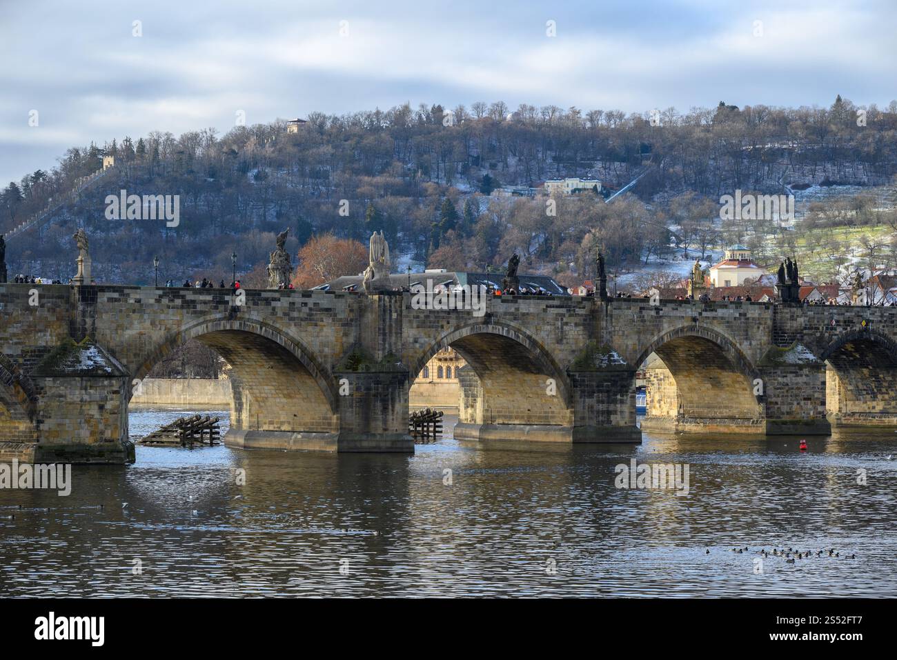 View of the famous Charles Bridge over Vltava river in winter, in ...