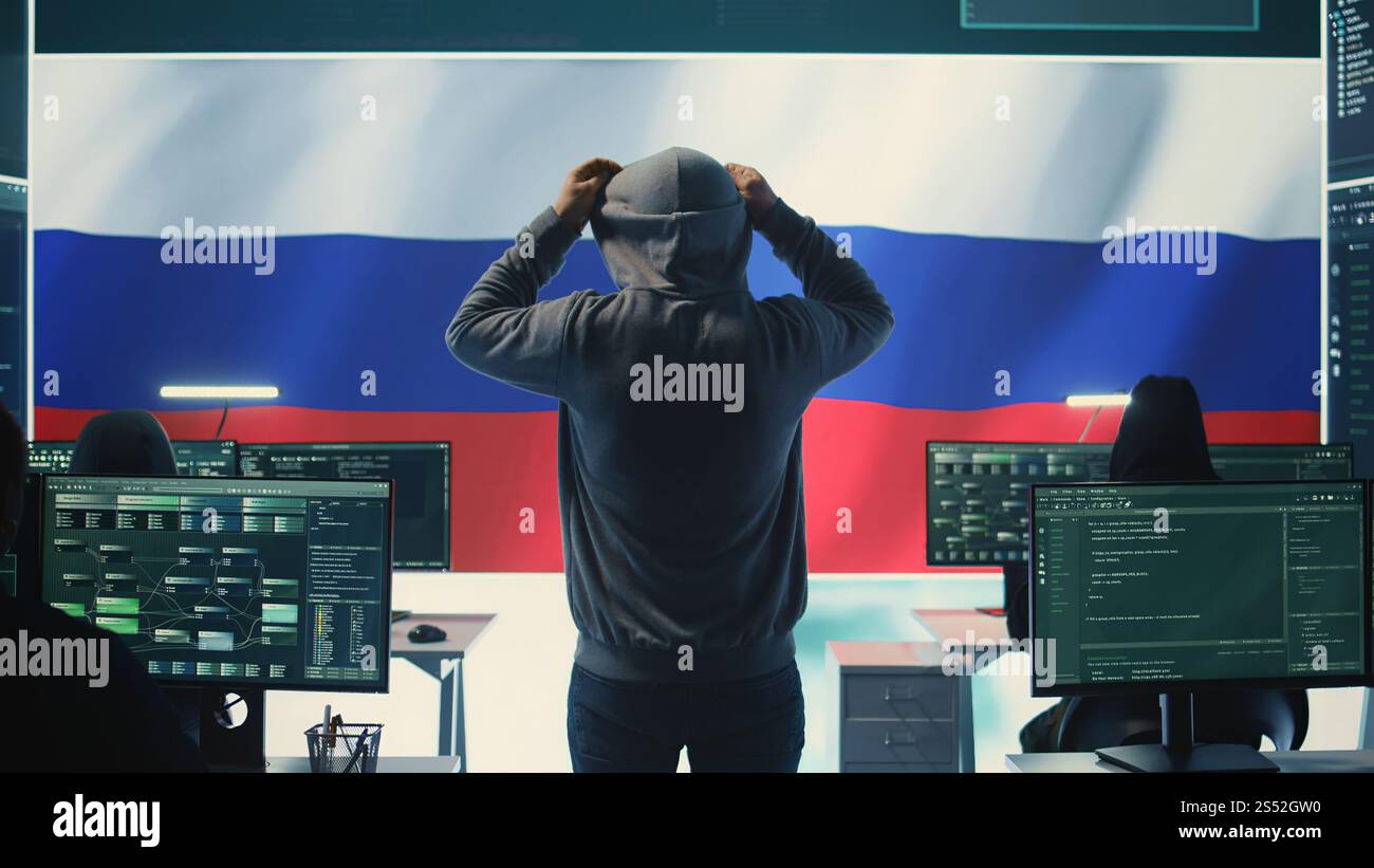 Russian hacker with a hood installing panic by misconception and ...