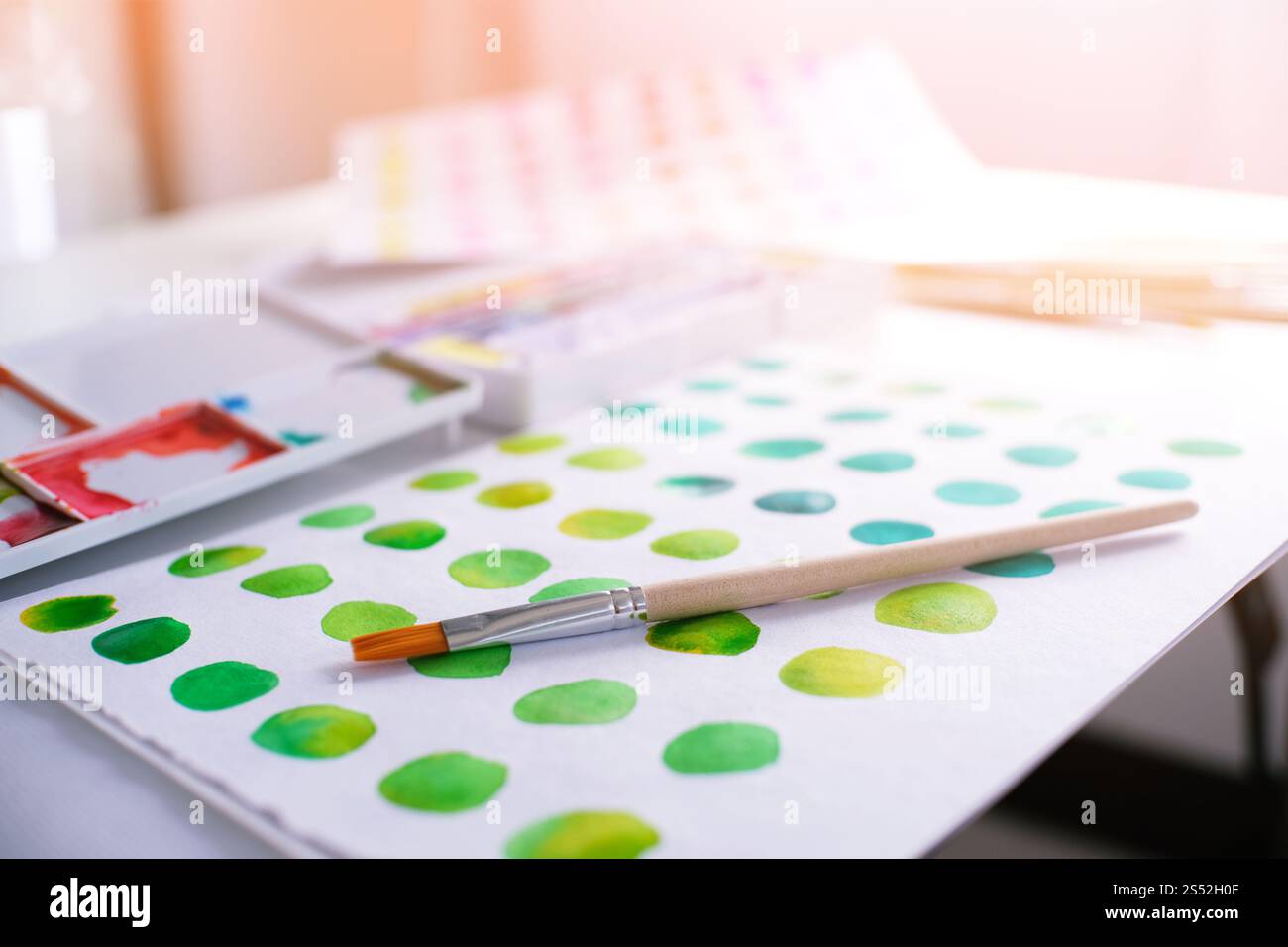Watercolor paints and brushes workplace artist with artistic tools for ...