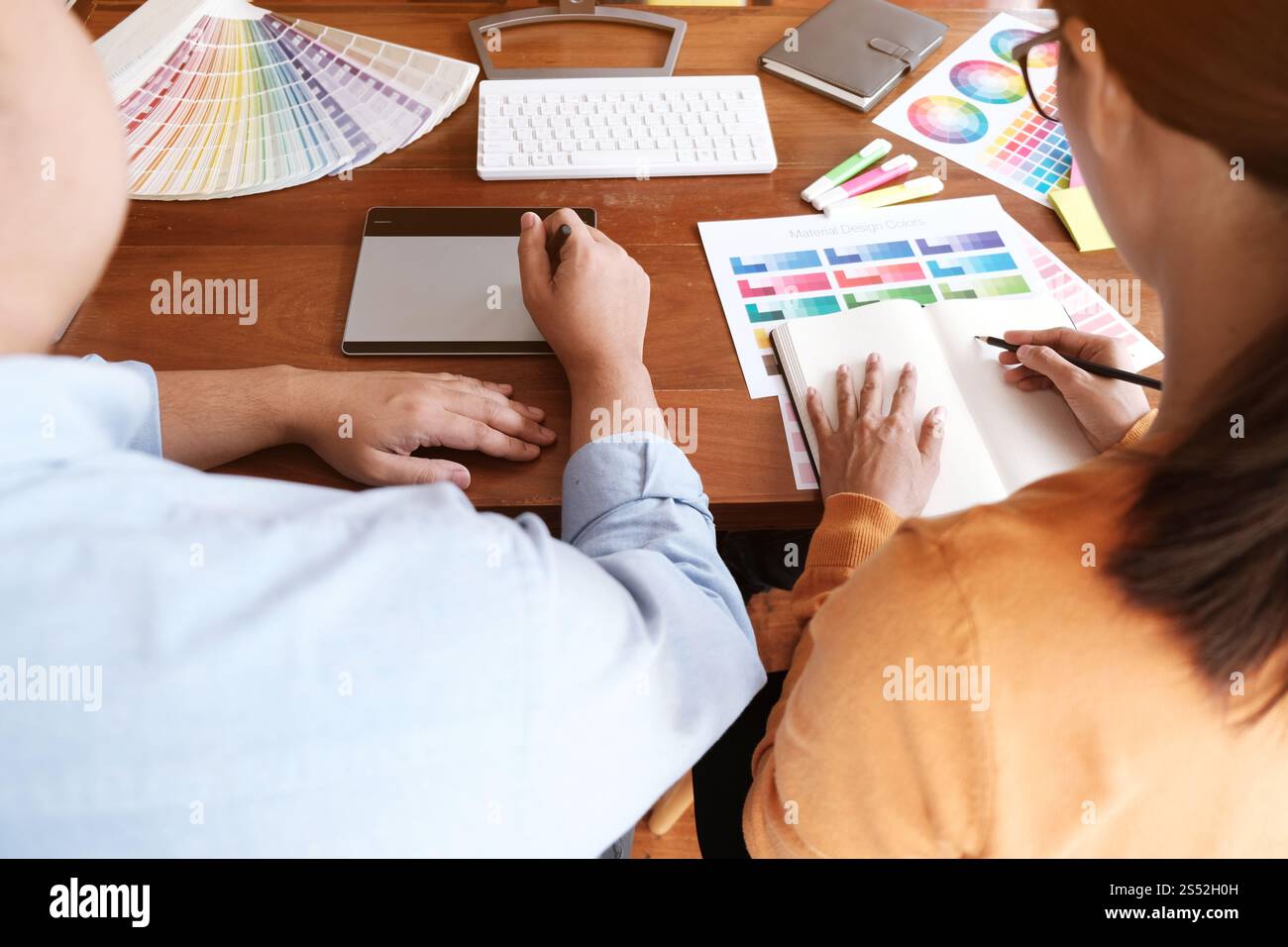 Graphic designer working on digital tablet. artist drawing on graphic tablet and Color swatch ...