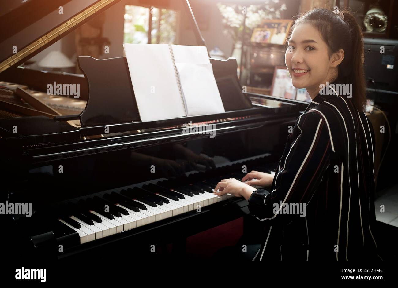 Beautiful asian girl learn to play piano Stock Photo - Alamy