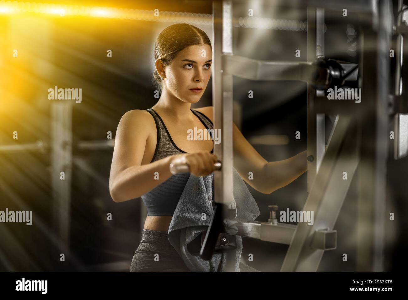 Girl In Gym Performs Exercises For Arm Muscles Using Simulators