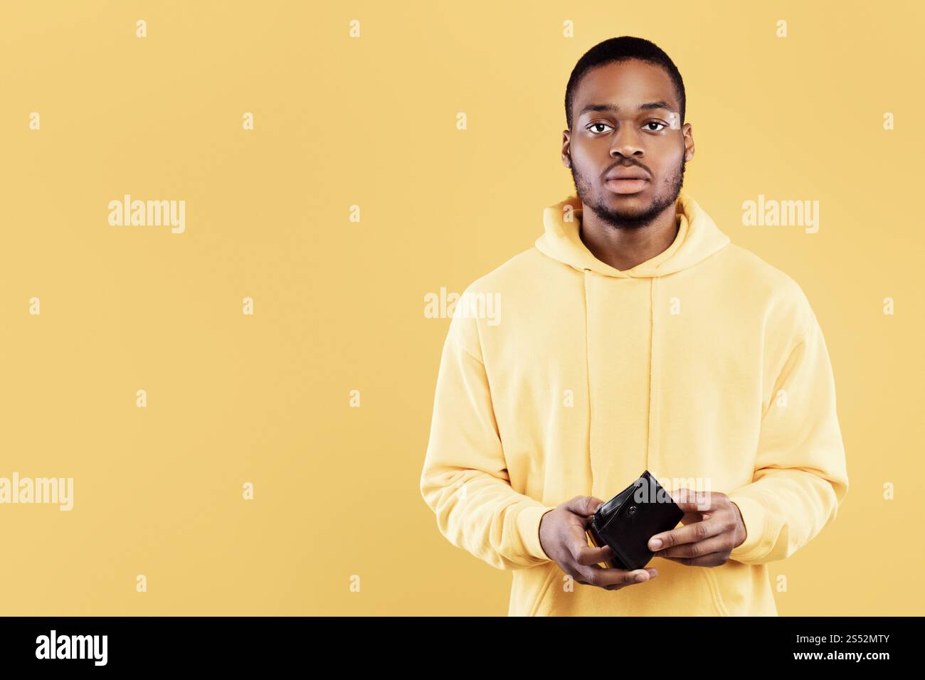Black Guy Showing Empty Wallet With No Money, Yellow Background Stock ...