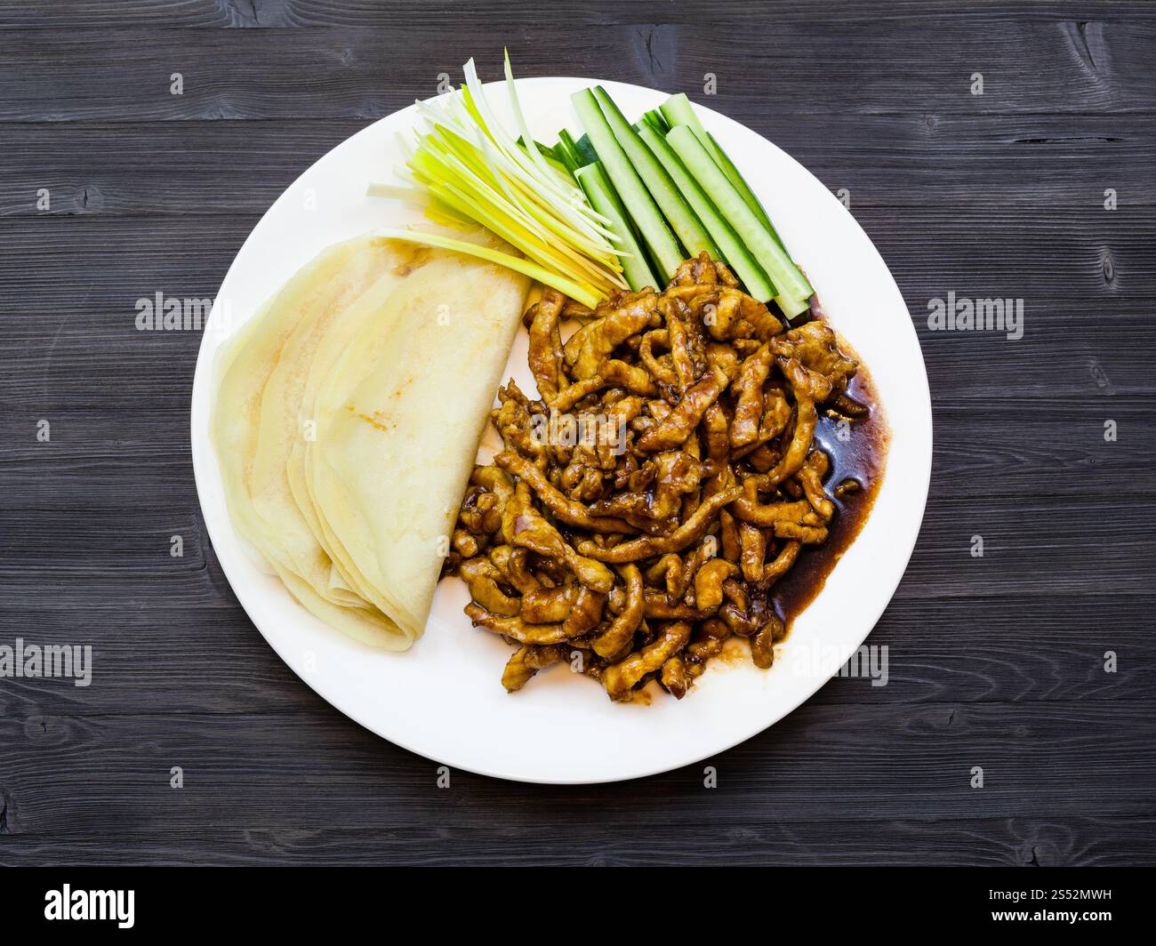 Chinese cuisine dish - top view white plate with sliced pork fried in ...
