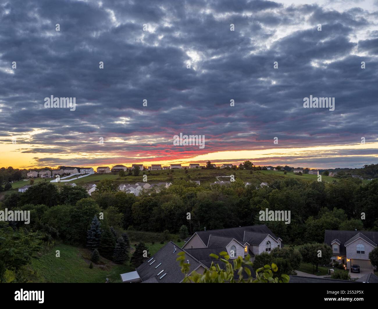A breathtakingly colorful sunset lights up the summer sky, casting ...
