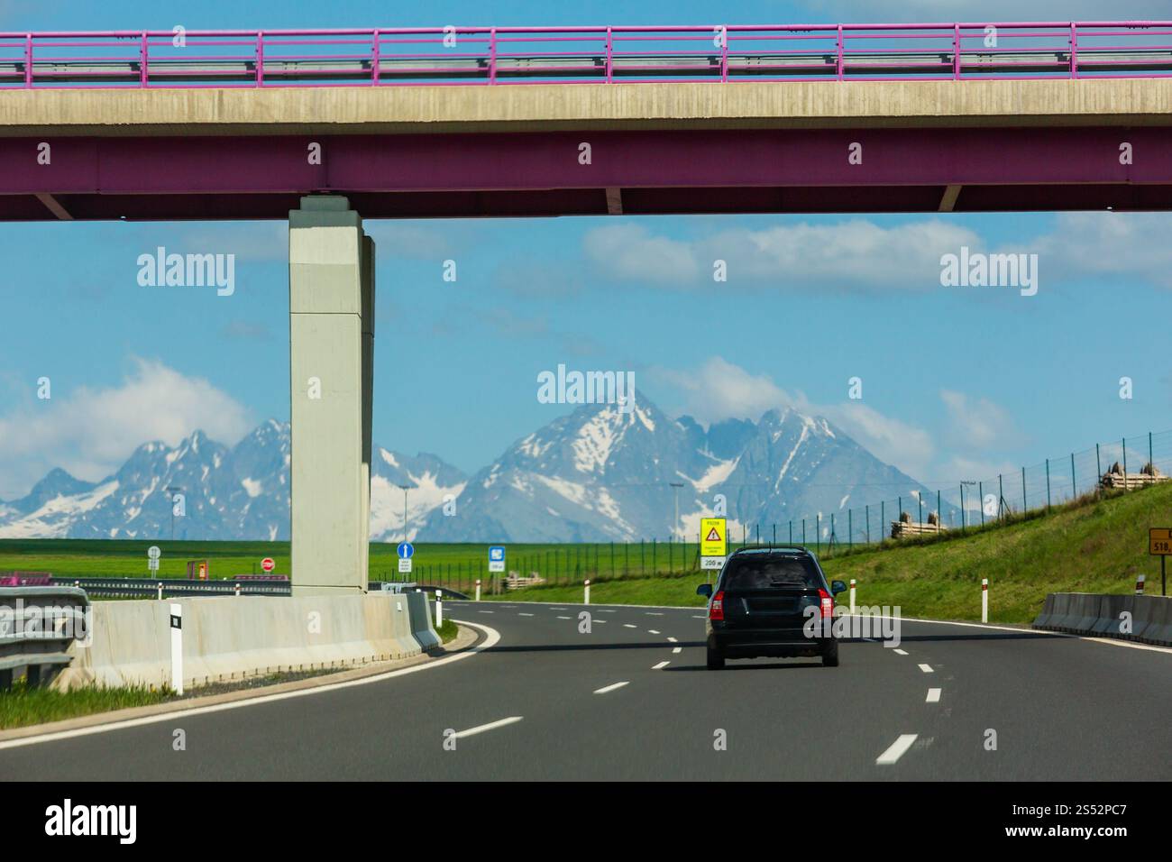 High Tatras spring view with snow on mountain tops from autobahn ...