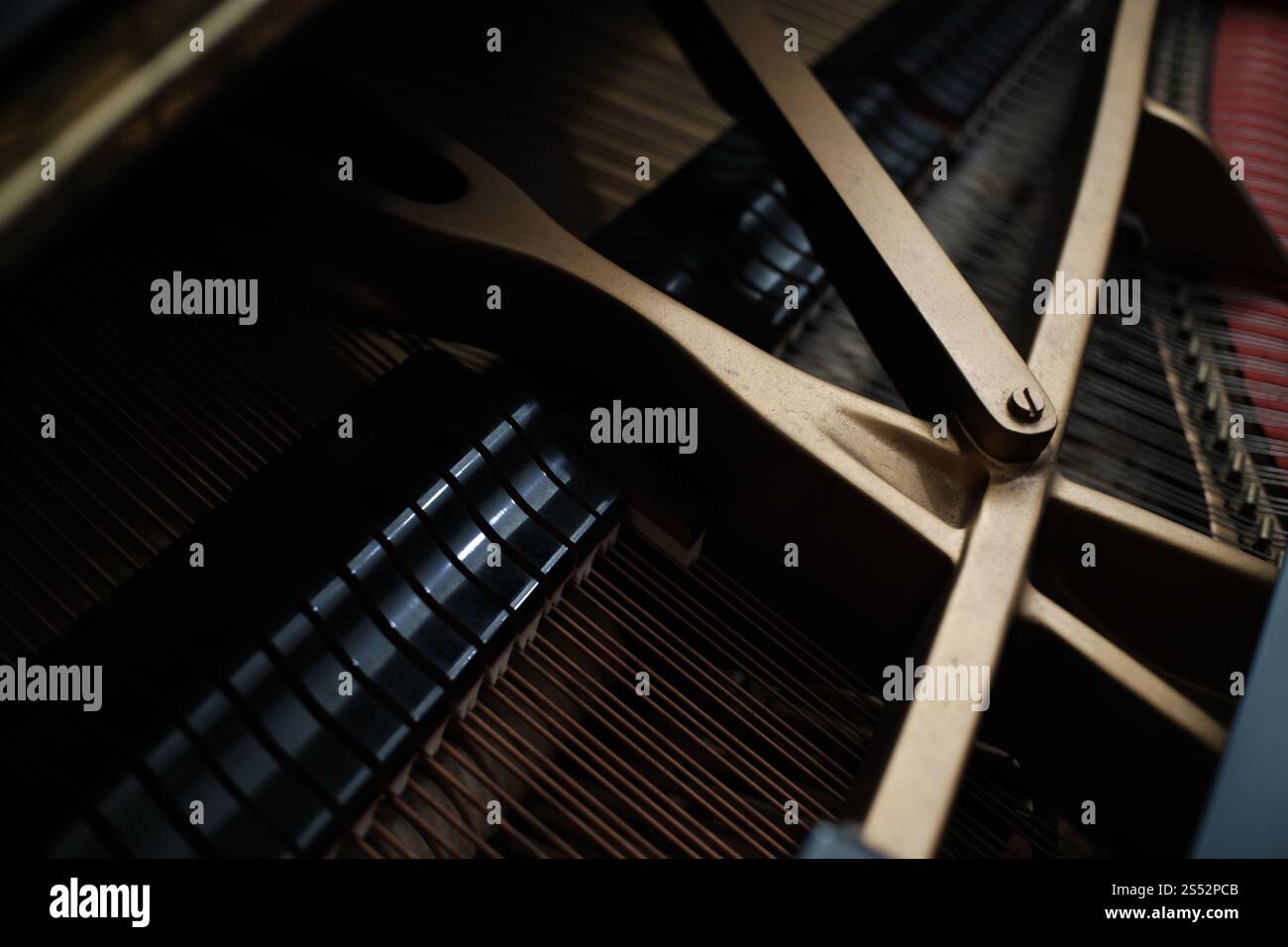 internal parts of an upright piano strings and a tuning key on the pins Stock Photo - Alamy