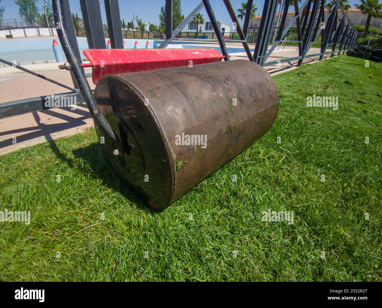 Lawn roller used to compact soil. Manual tools for lawn maintenance ...