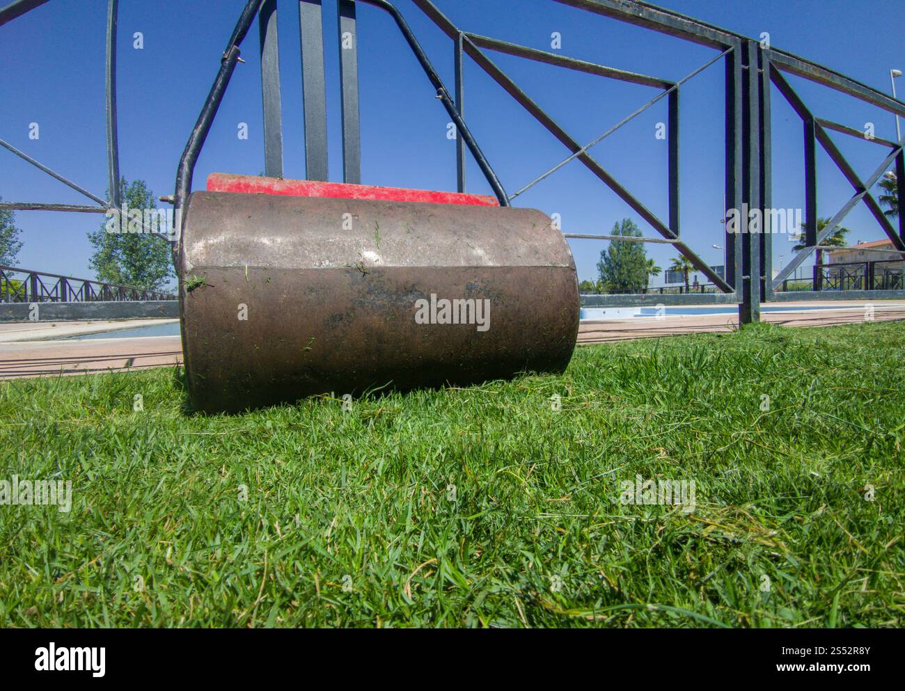 Lawn roller used to compact soil. Manual tools for lawn maintenance ...