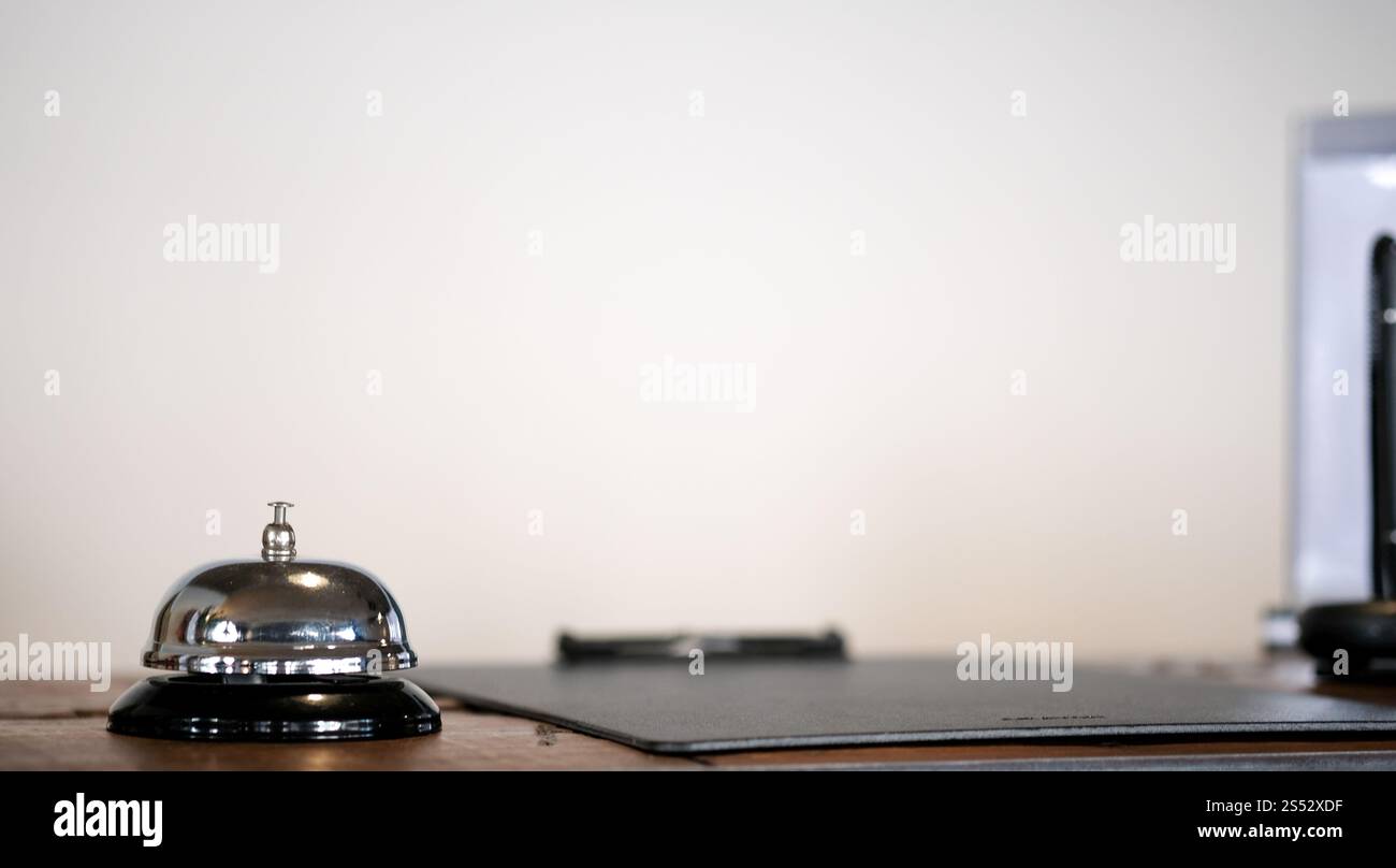 Hotel reception counter desk with service bell Stock Photo - Alamy