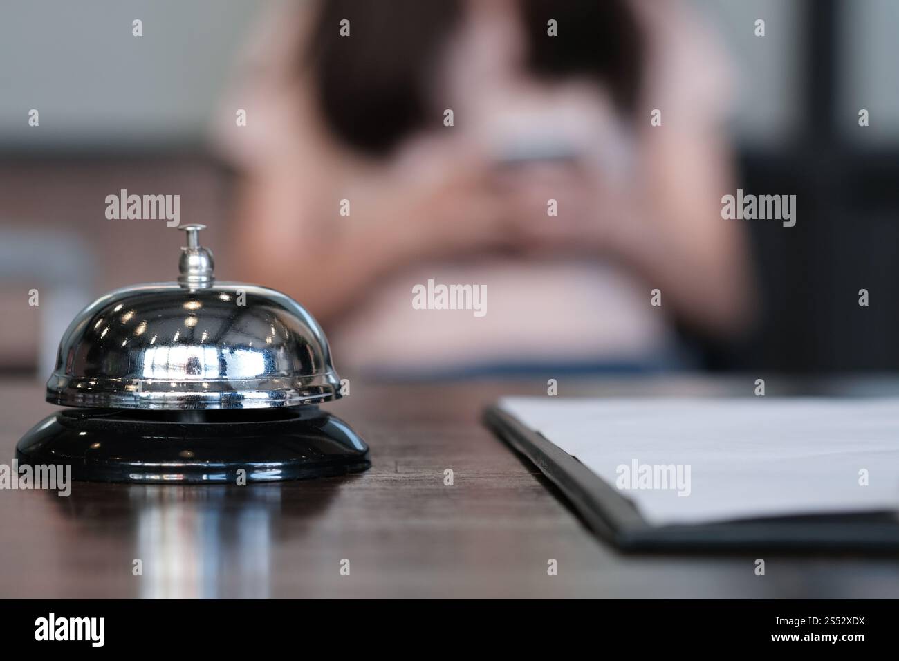 Hotel reception counter desk with service bell Stock Photo - Alamy