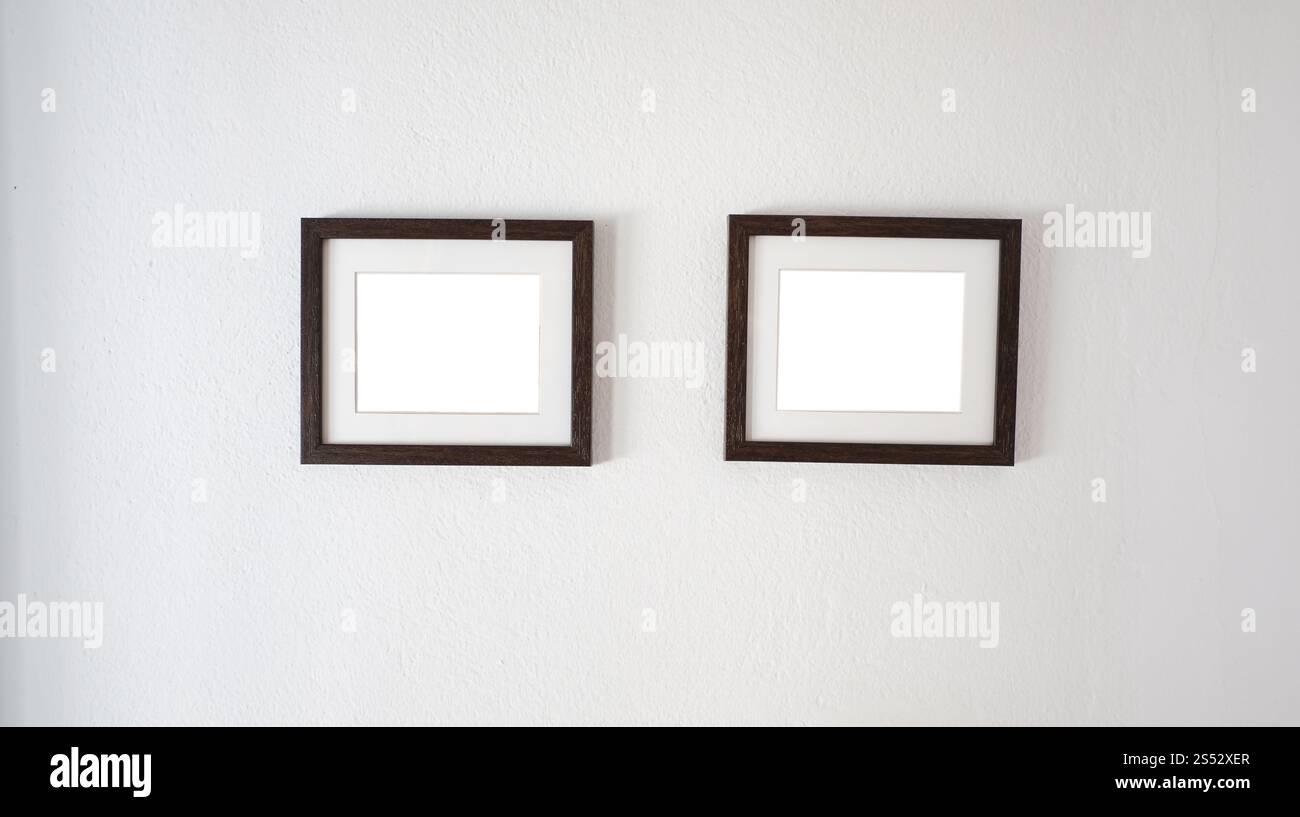 Empty white frame on a wall for mock up Stock Photo - Alamy