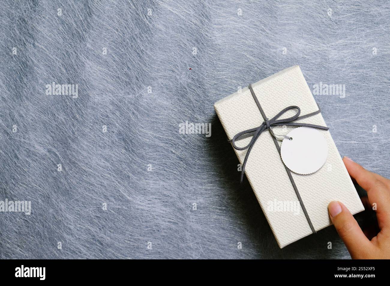 Woman taking gift box out of parcel Stock Photo - Alamy