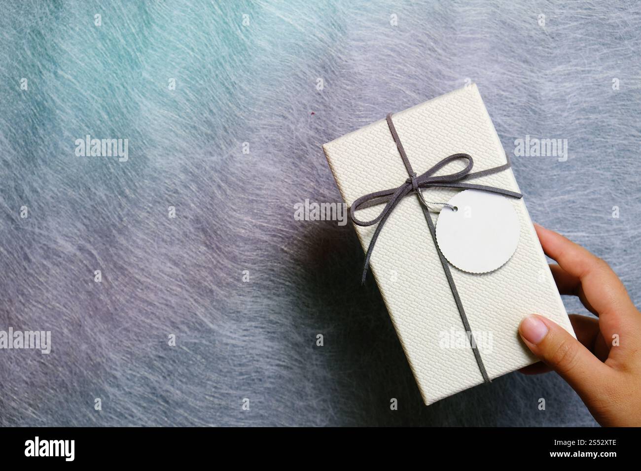 Woman taking gift box out of parcel Stock Photo - Alamy