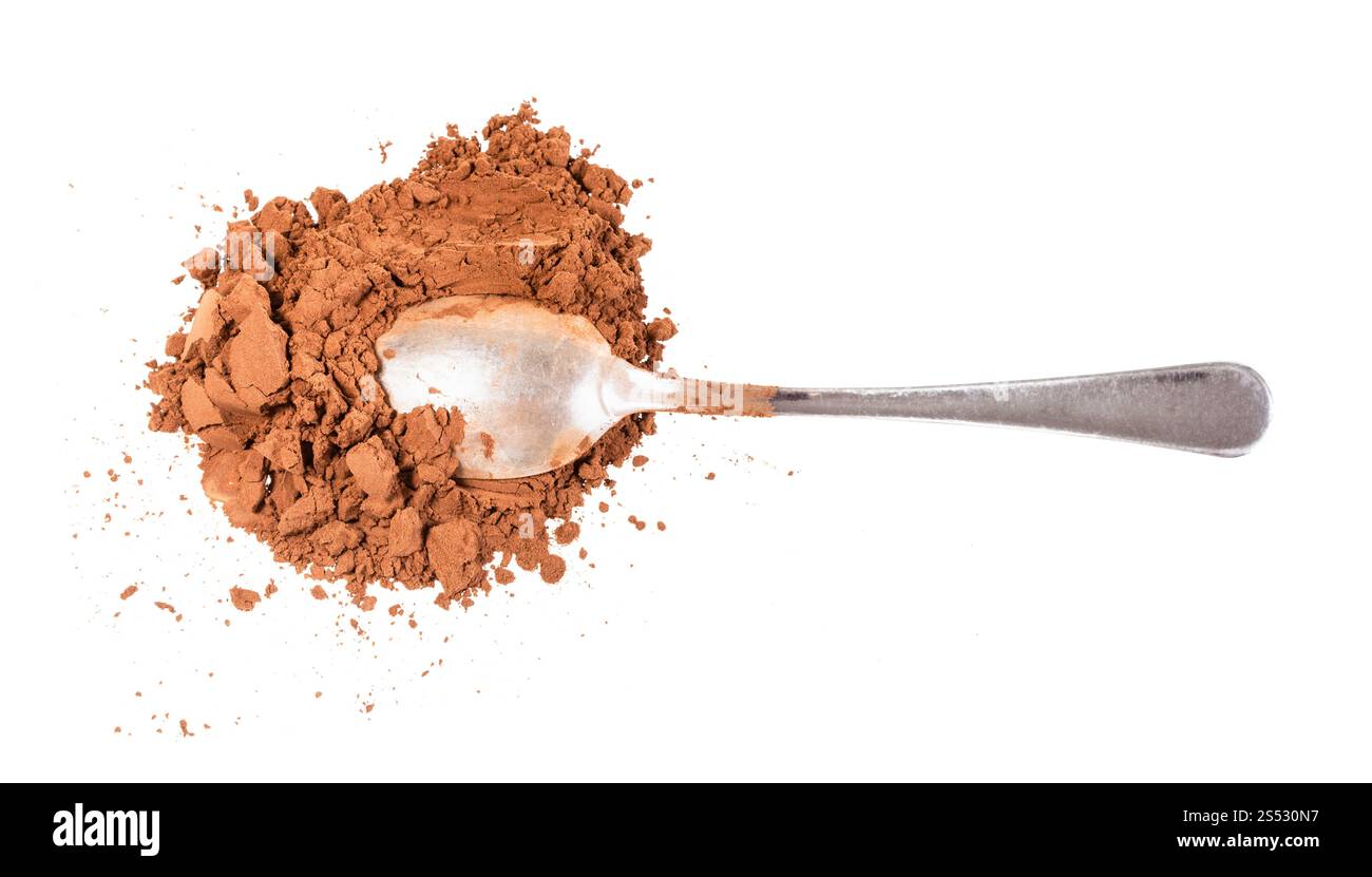 top view of spoon in pile of ground carob powder isolated on white ...