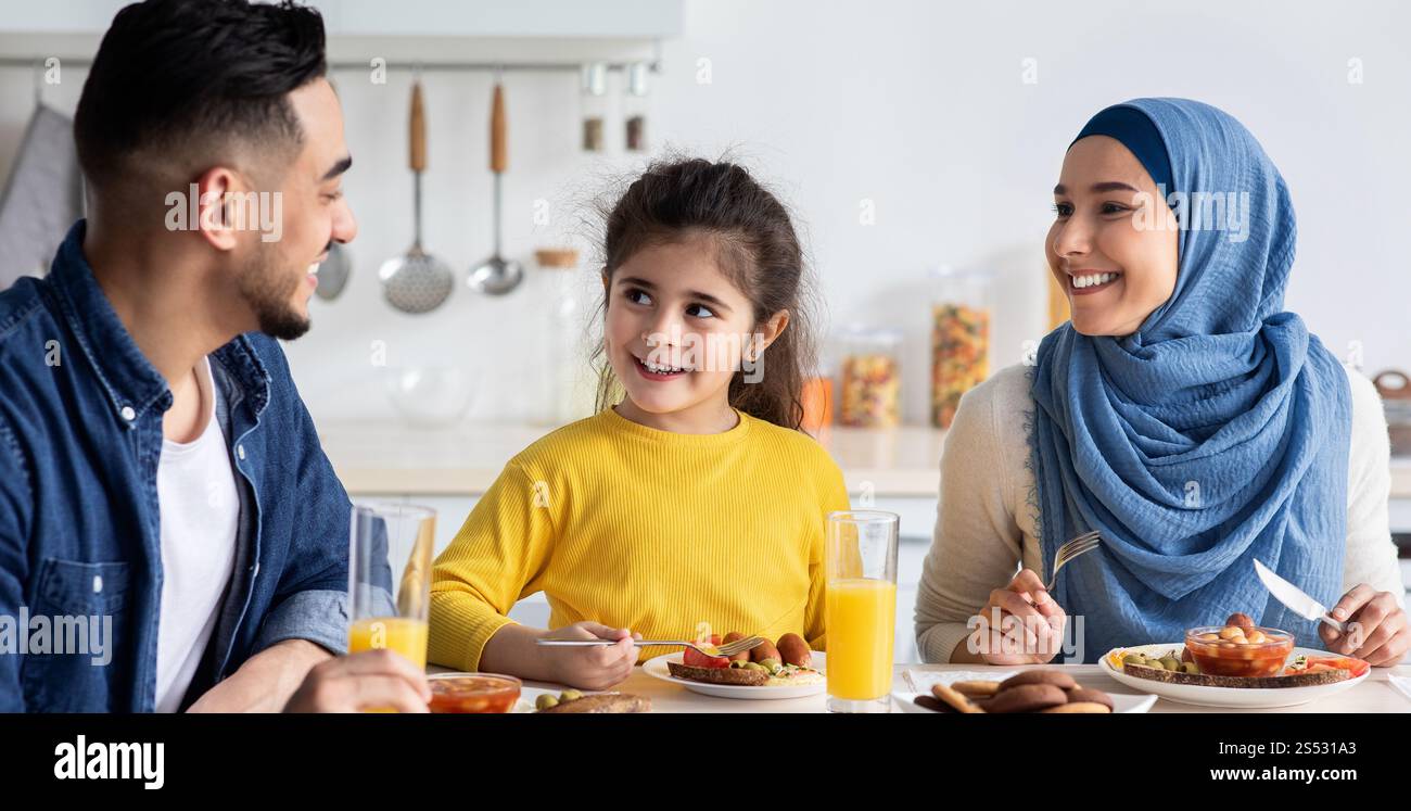 Cheerful Modern Muslim Family With Little Daughter Eating Breakfast ...
