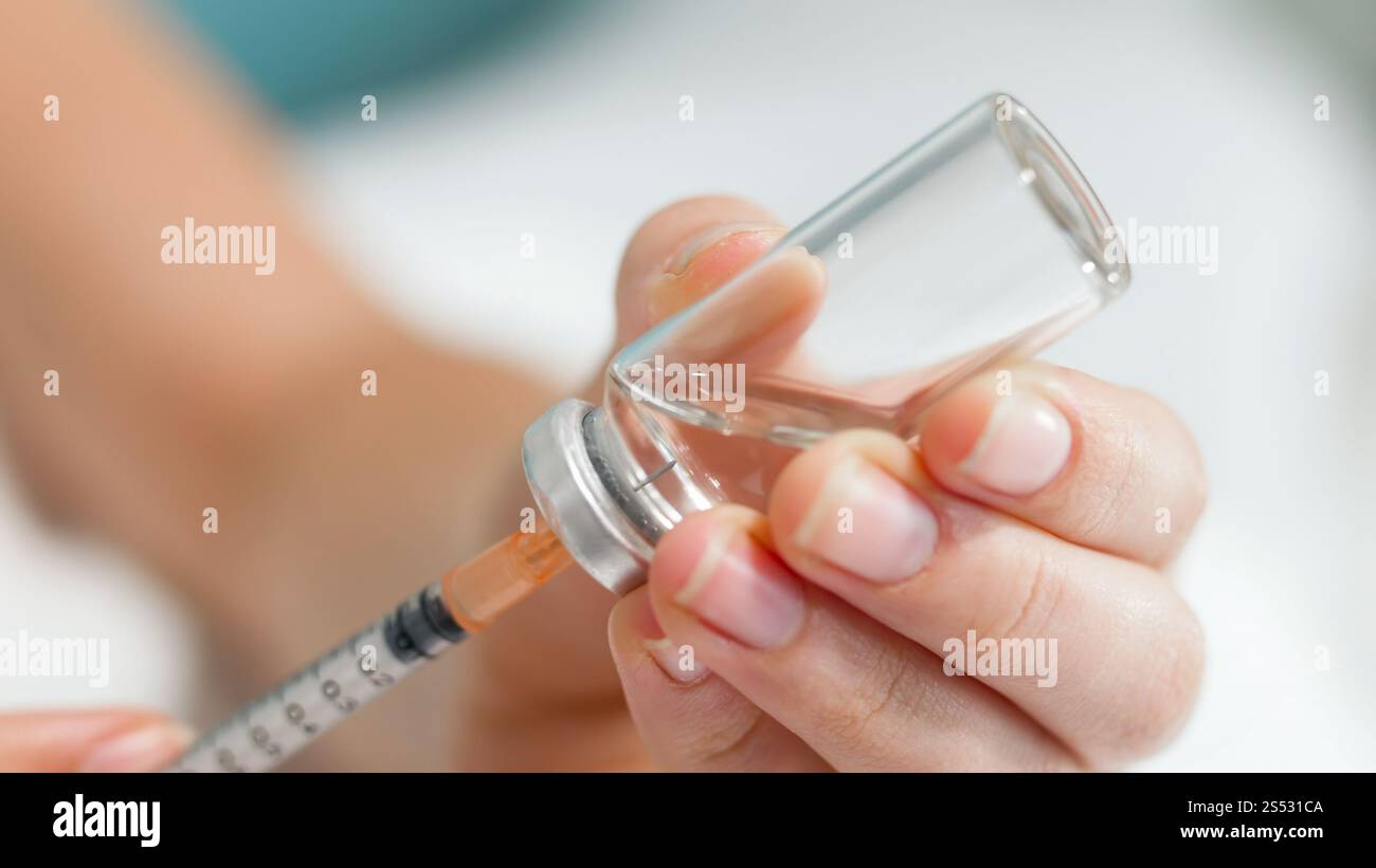 Macro photo of syringe needle in ampule with medicines. Macro image of ...