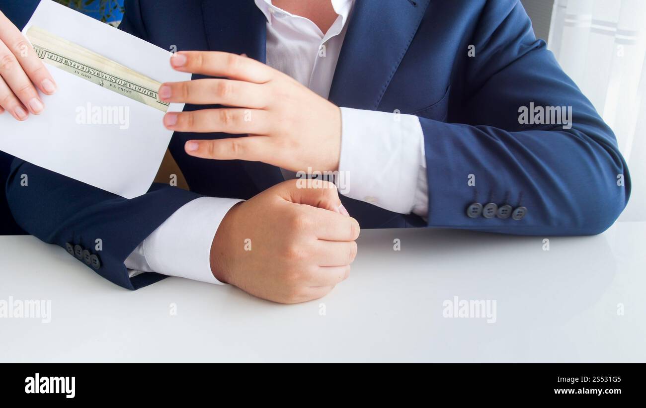 Closeup photo of corrupted official receiving bribe in envelope at ...