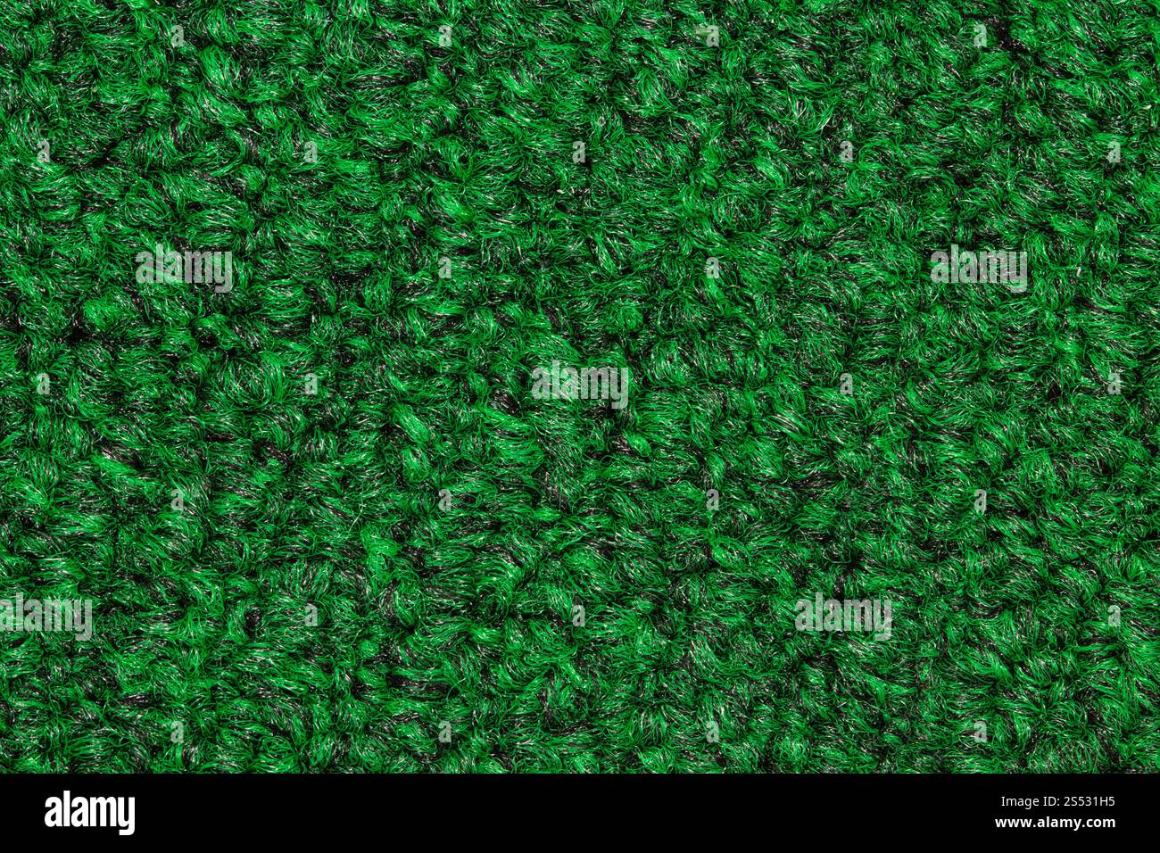 Green nylon yarn woven mat background textured carpet sample closeup ...