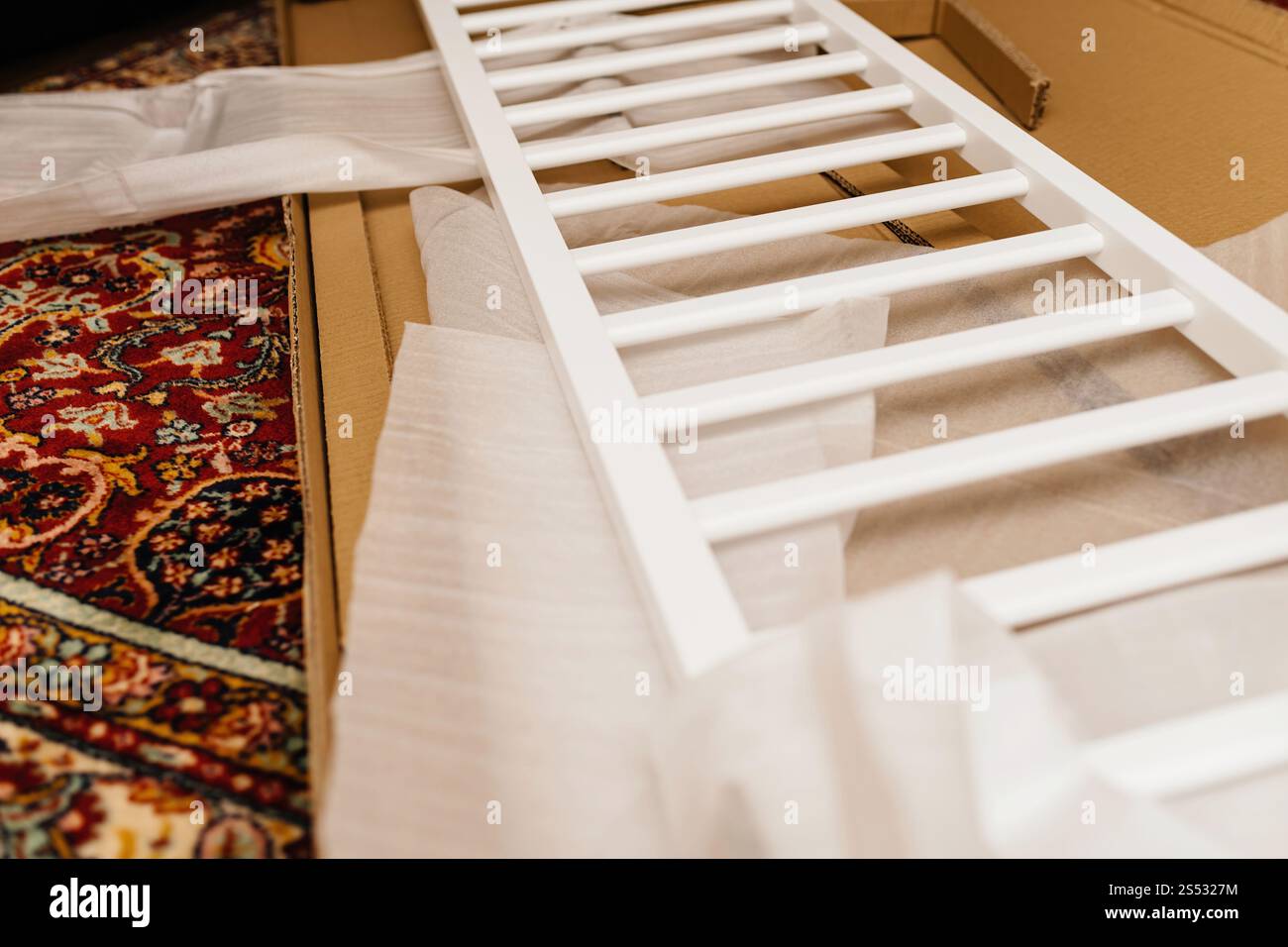 Unassembled white furniture part, carefully wrapped and placed on a ...