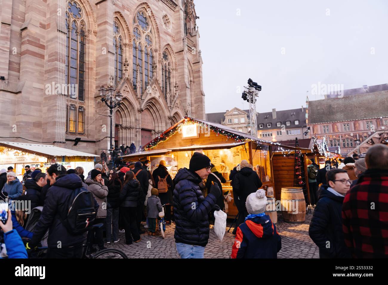 Mulhouse, France - Dec 26, 2024: Visitors enjoying traditional food and ...